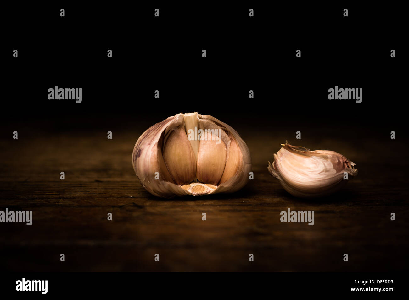 Broken up garlic on wood surface Stock Photo - Alamy