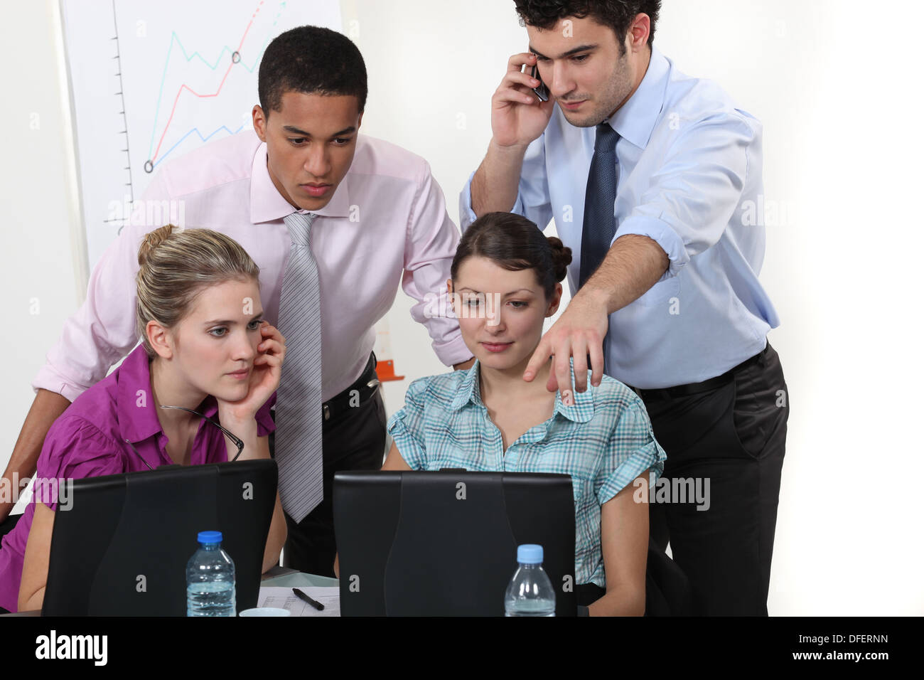 Office workers gathered around computer hi-res stock photography and ...