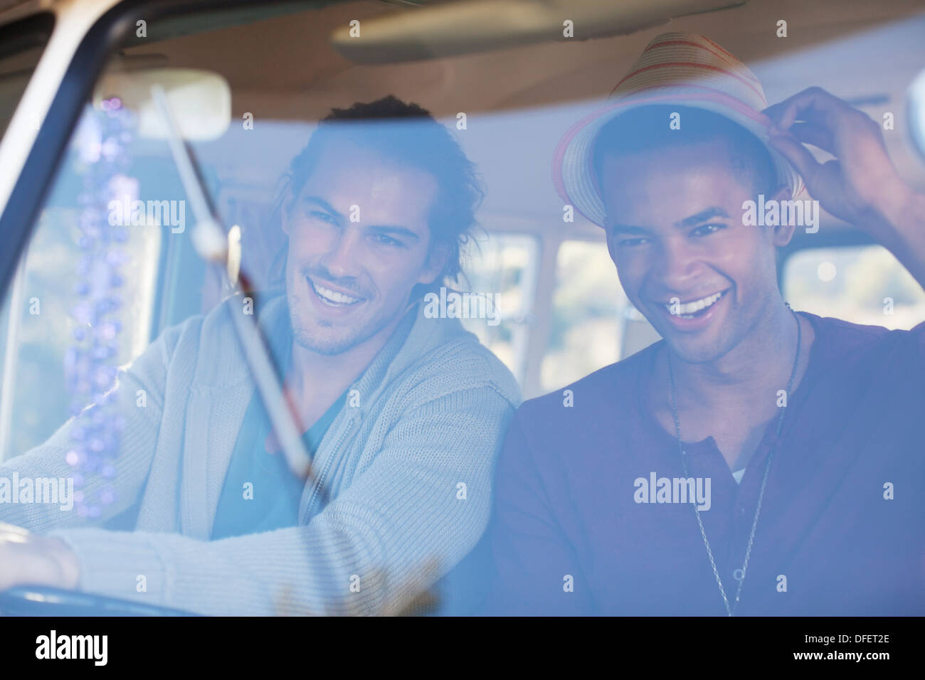 Men smiling in camper van Stock Photo - Alamy