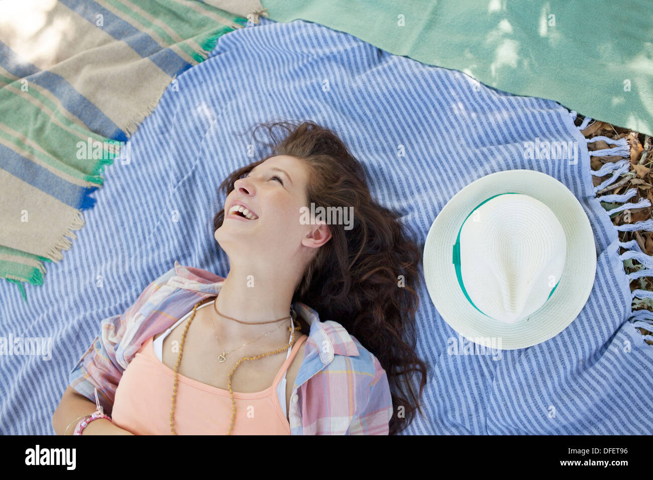 Woman laying on blanket outdoors Stock Photo - Alamy