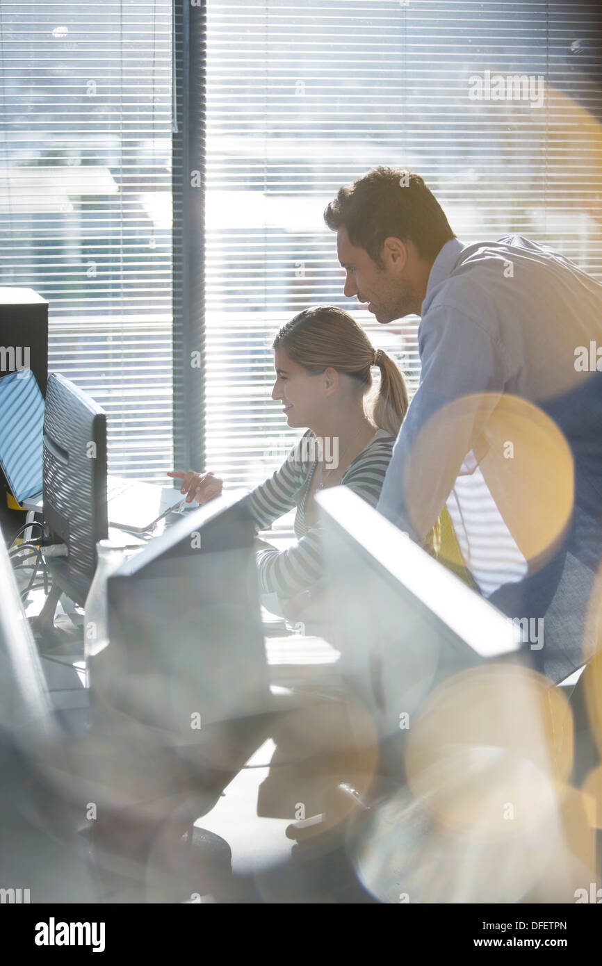 Business people working at computer next to window Stock Photo - Alamy