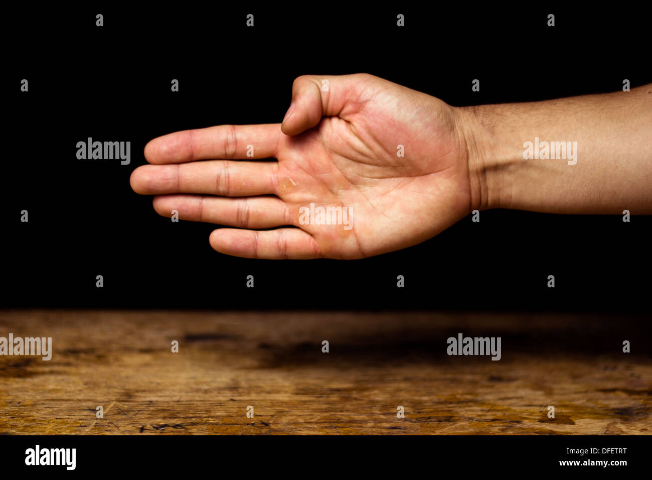 Male hand offering handshake on black background Stock Photo - Alamy