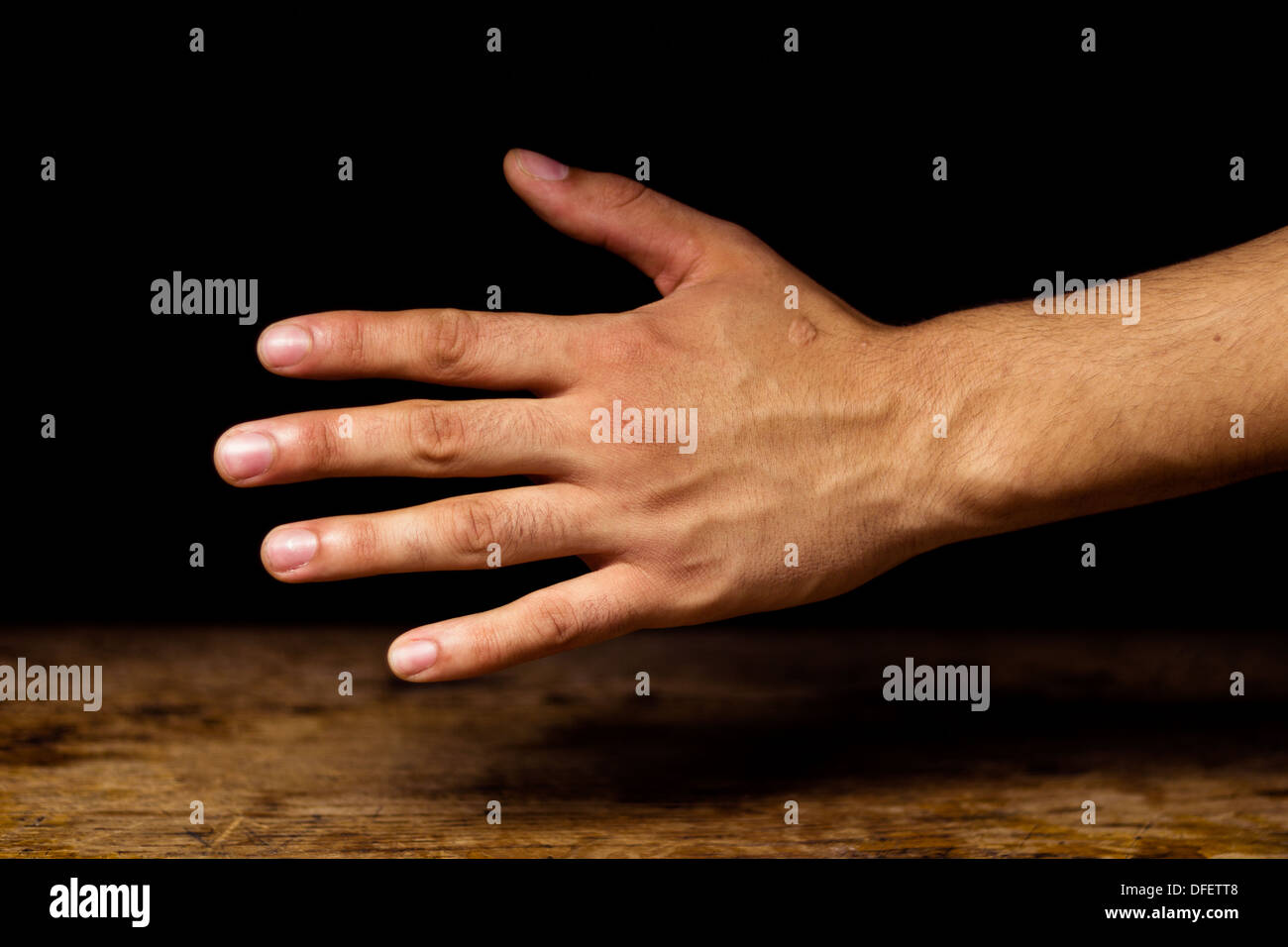 Back of man's left hand on black background Stock Photo - Alamy