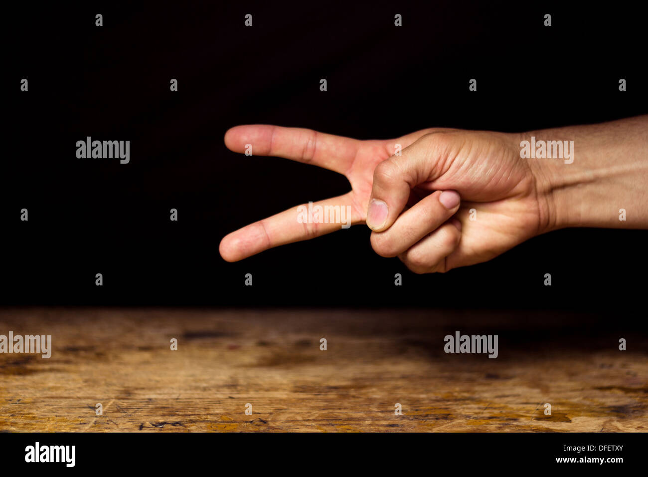 Male hand doing scissor sign Stock Photo - Alamy