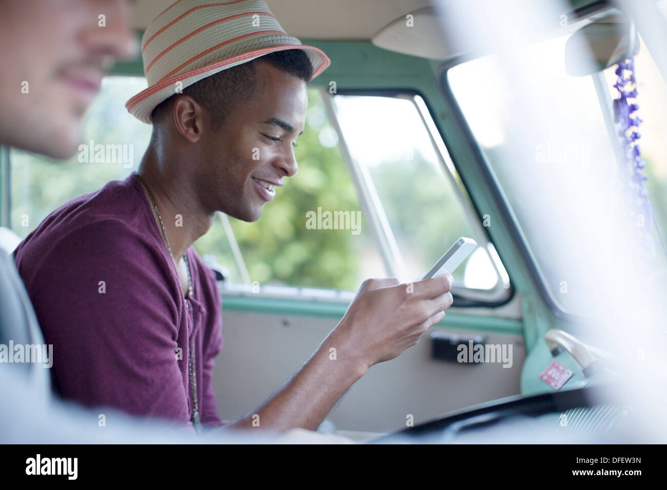 Man using cell phone in camper van Stock Photo - Alamy