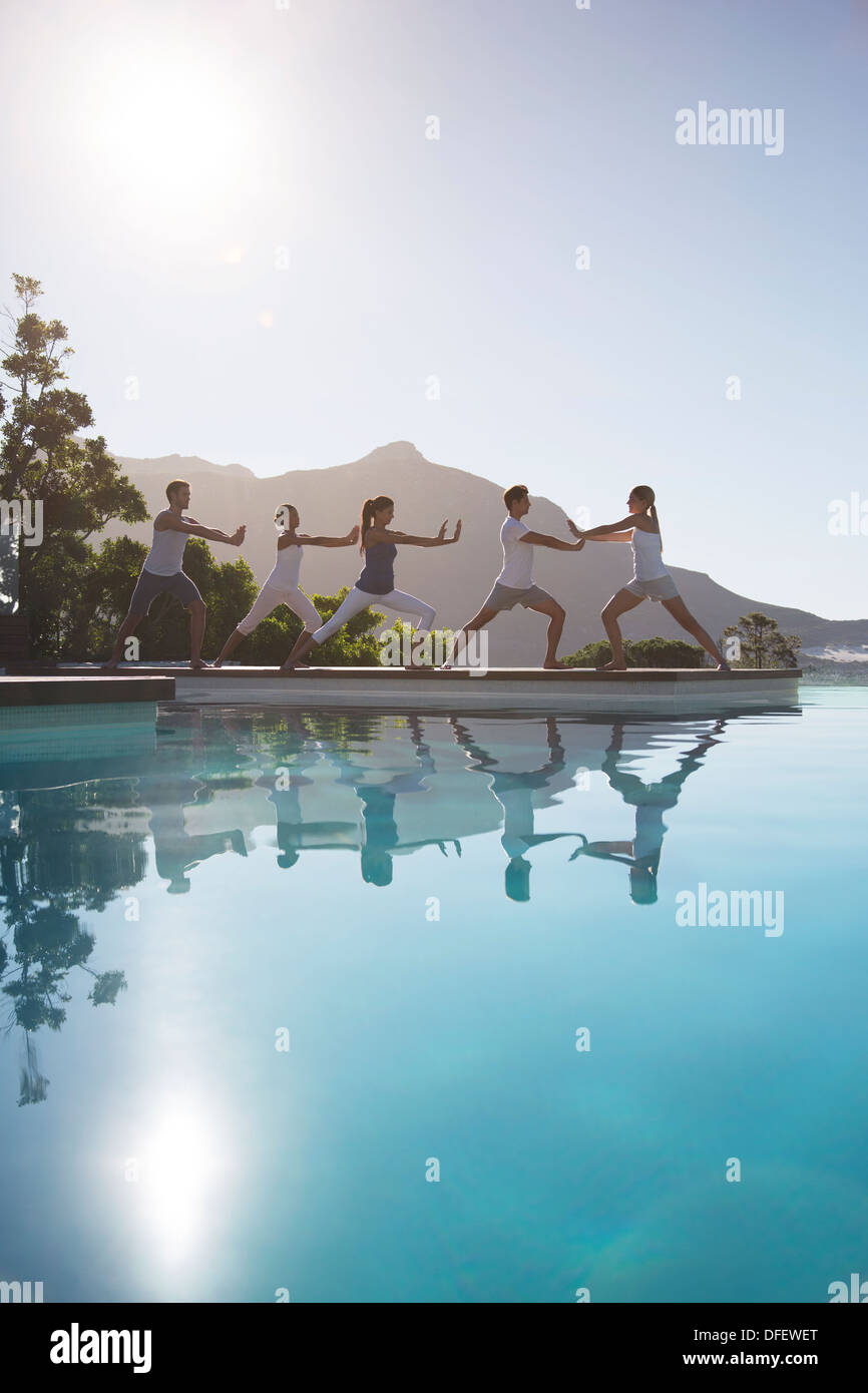 People practicing yoga at poolside Stock Photo - Alamy