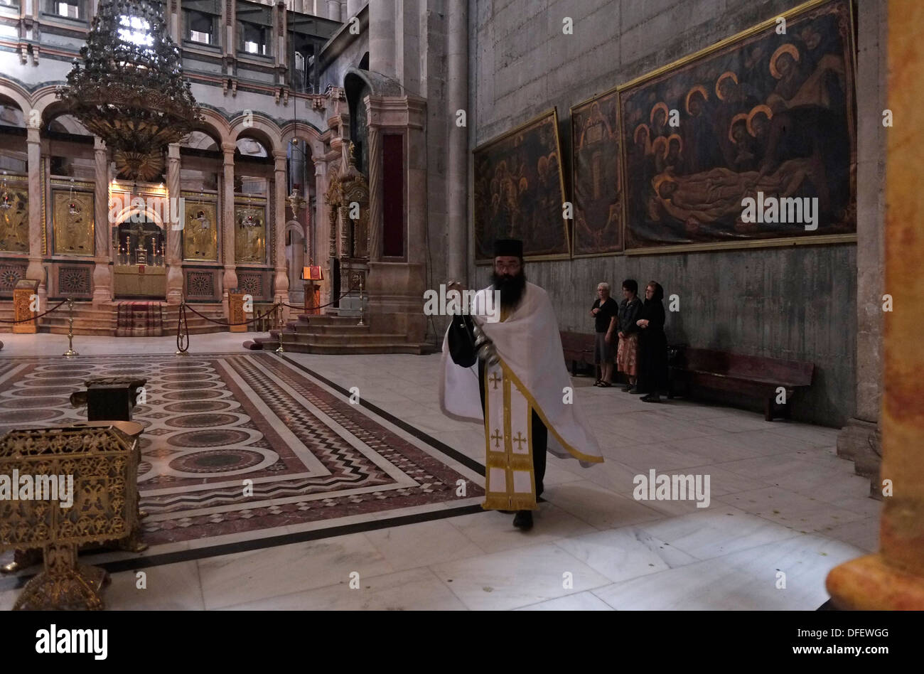 A Greek Orthodox priest censing with thurible inside the Katholikon or ...