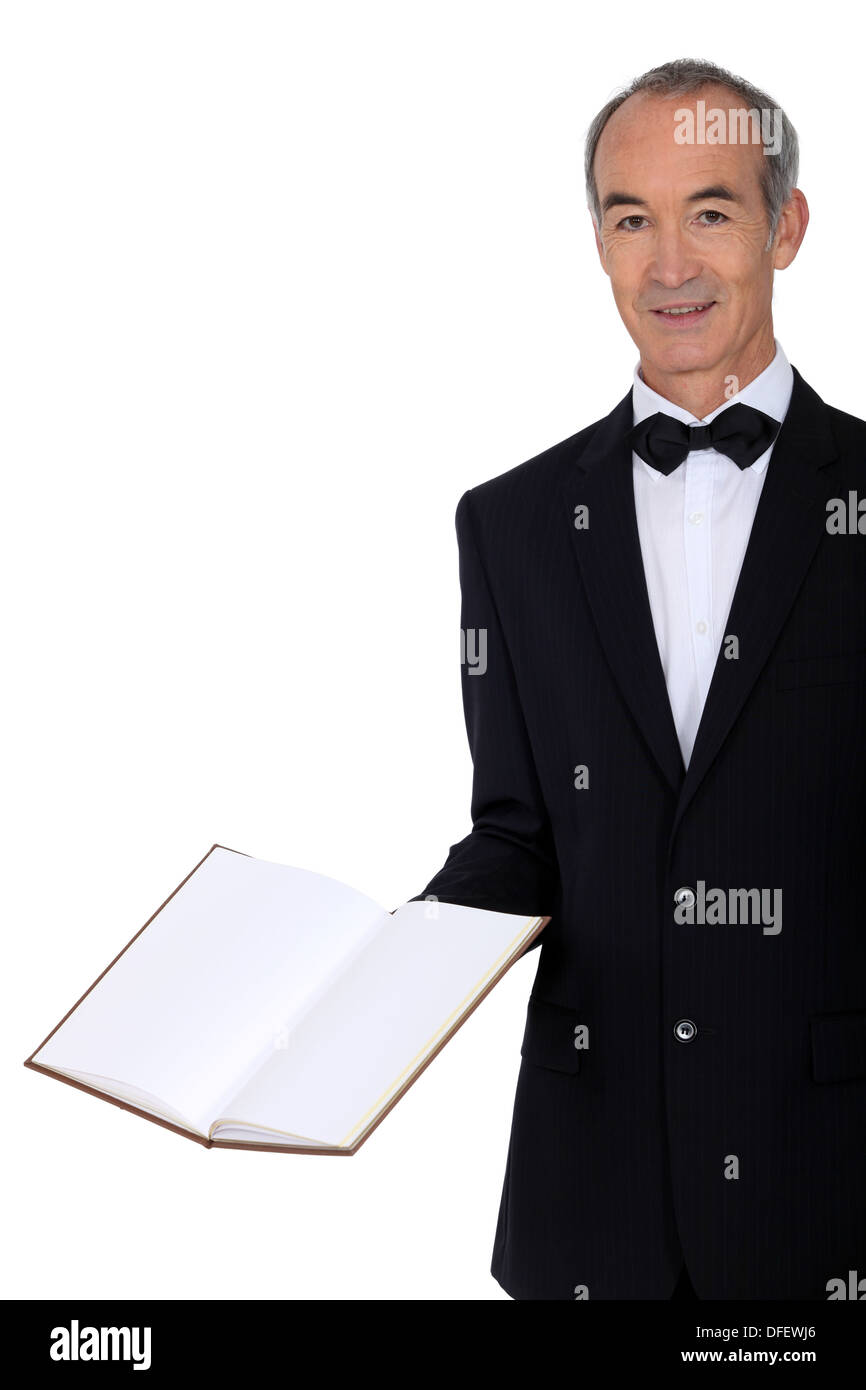 Middle-aged waiter holding menu Stock Photo - Alamy