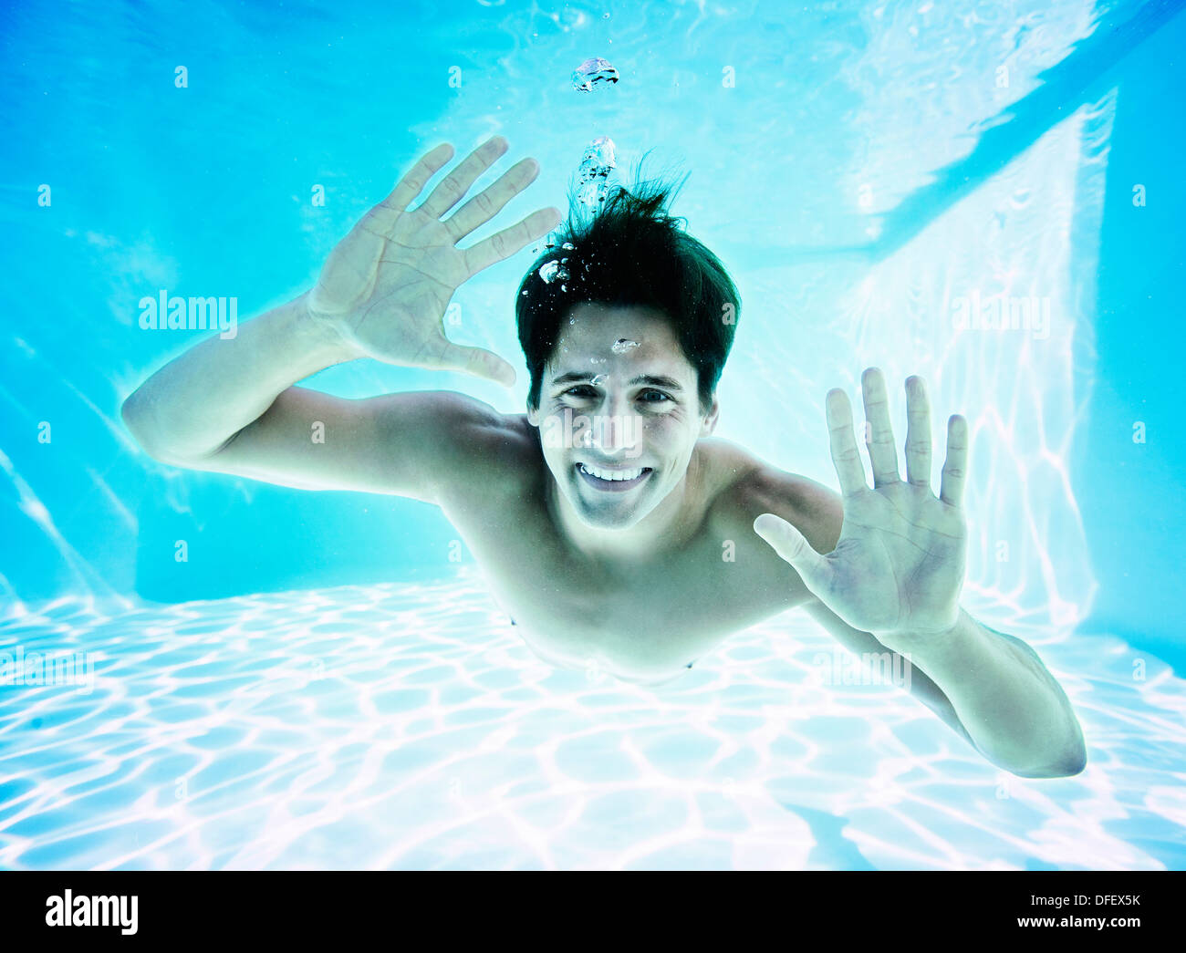 Portrait of man smiling underwater in swimming pool Stock Photo - Alamy
