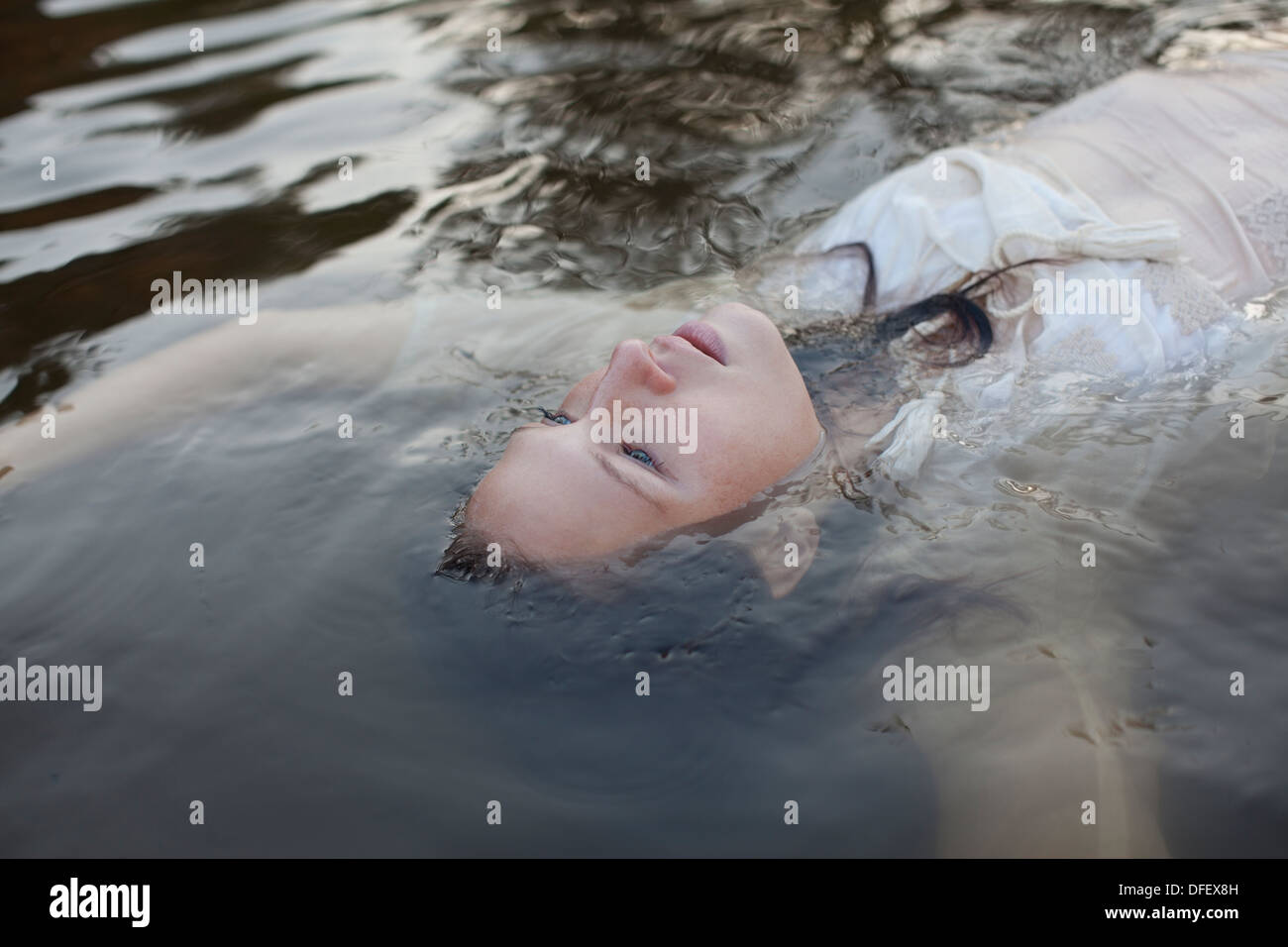 Woman floating in lake Stock Photo - Alamy