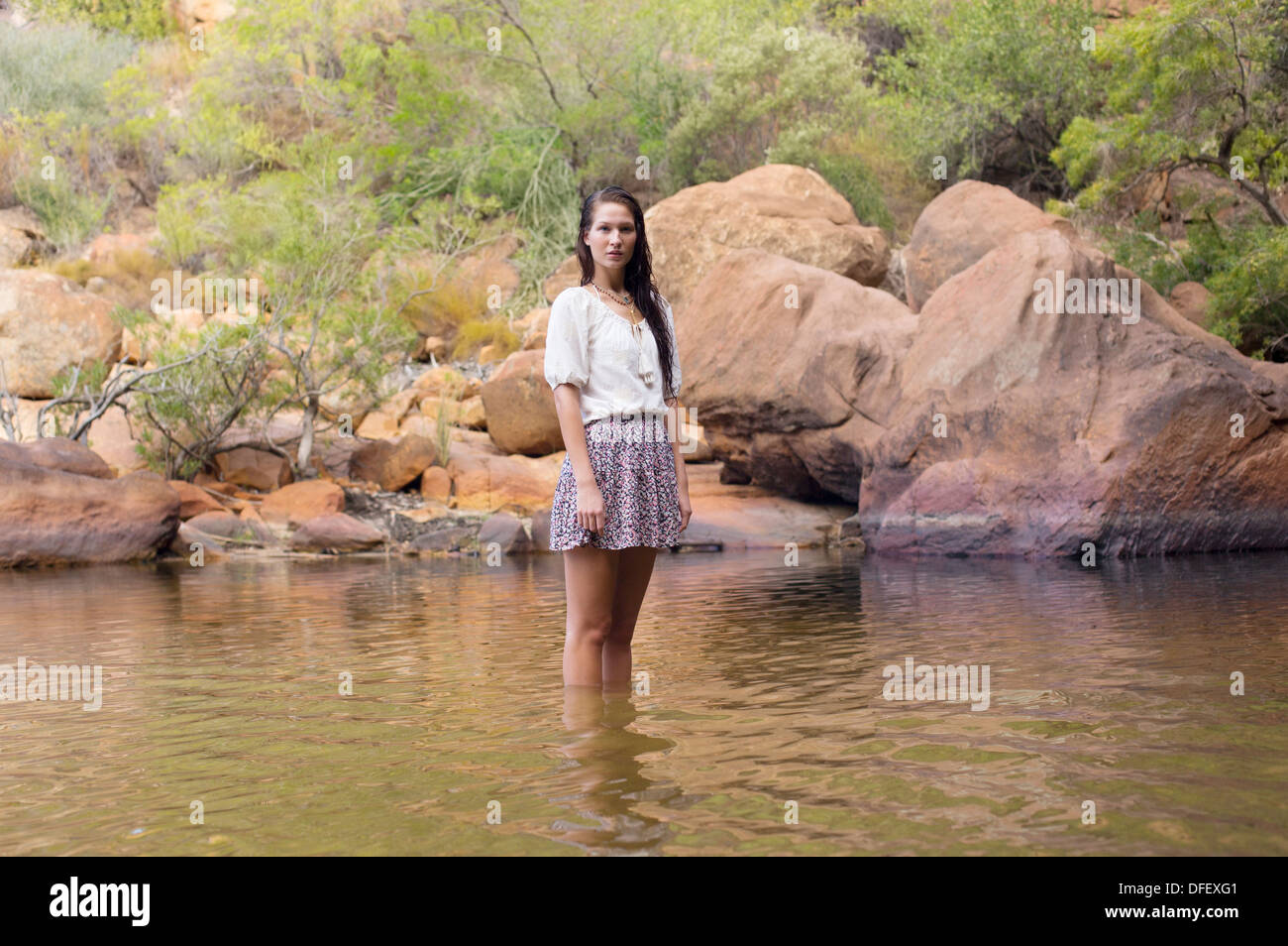 Portrait of woman wading in river Stock Photo - Alamy