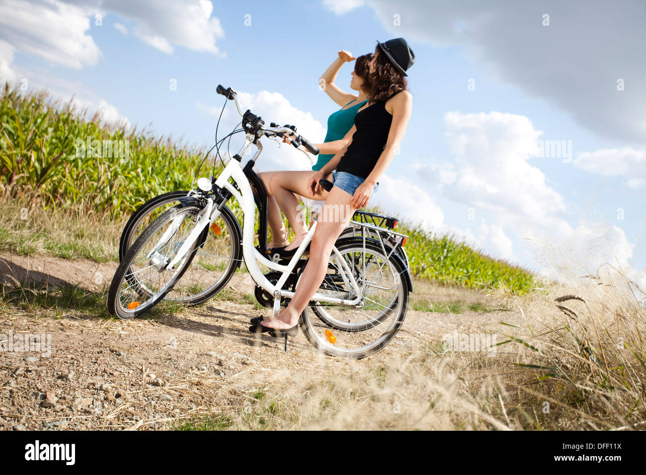 Young women riding bike Stock Photo - Alamy