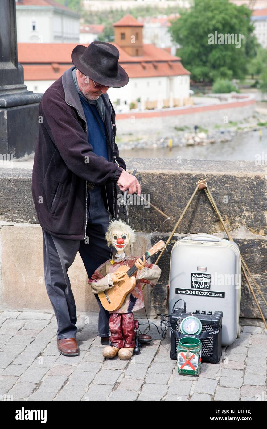 An entertainer with his marionette on the Charles Bridge in Prague ...