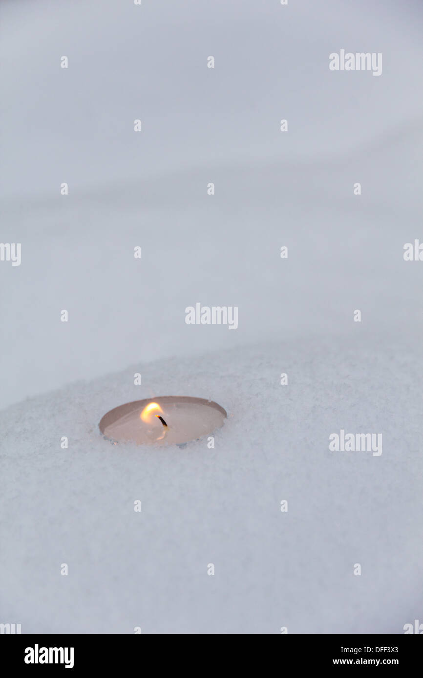 simple candle on the snow, in the night Stock Photo - Alamy