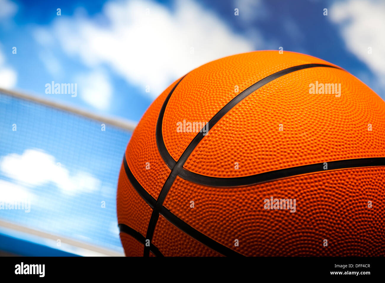 Basketball ball over blue sky background Stock Photo - Alamy