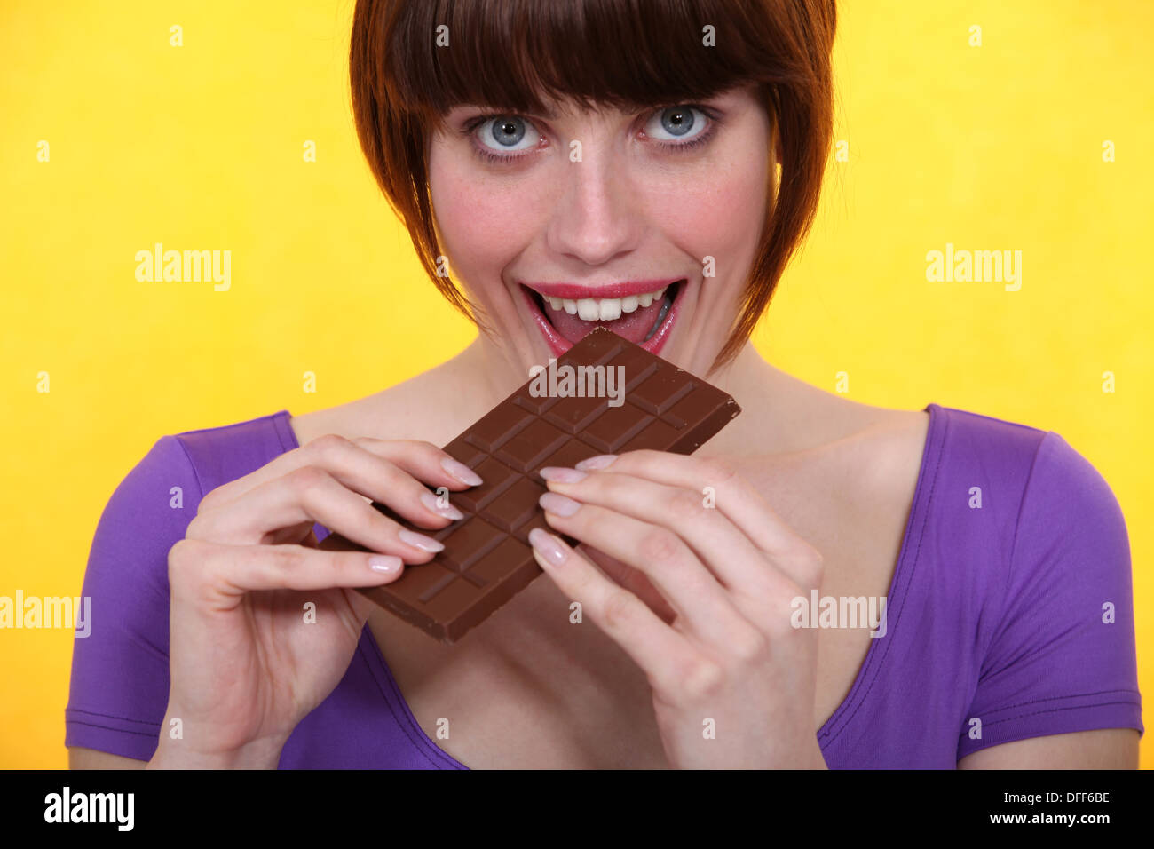 Gourmand woman eating chocolate Stock Photo - Alamy