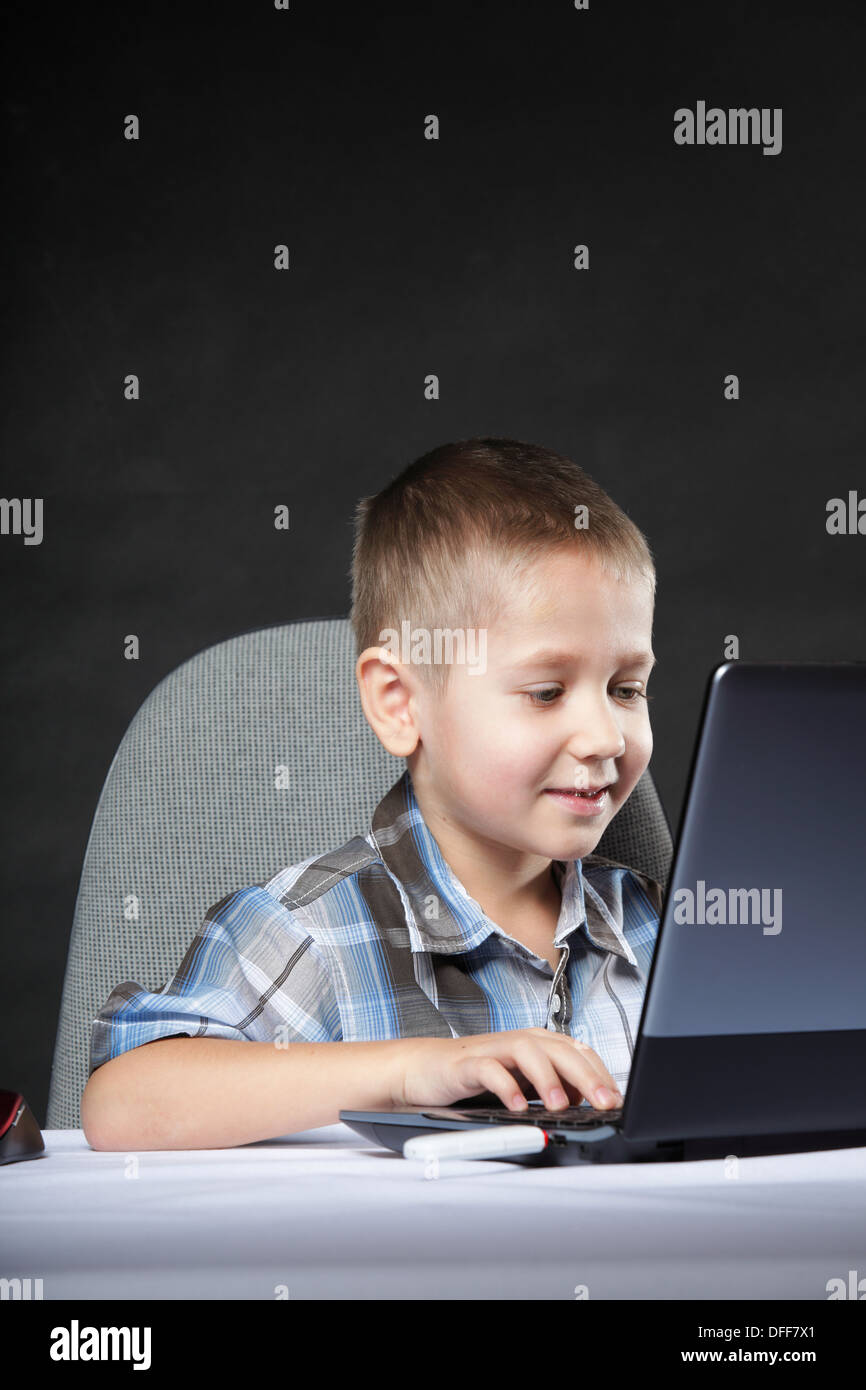 Computer addiction child boy with laptop notebook black background ...