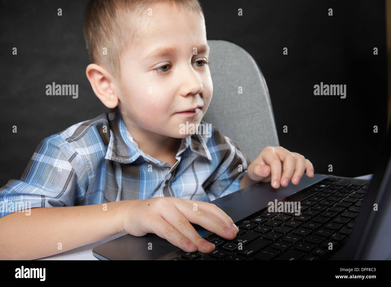 Computer addiction child boy with laptop notebook black background ...
