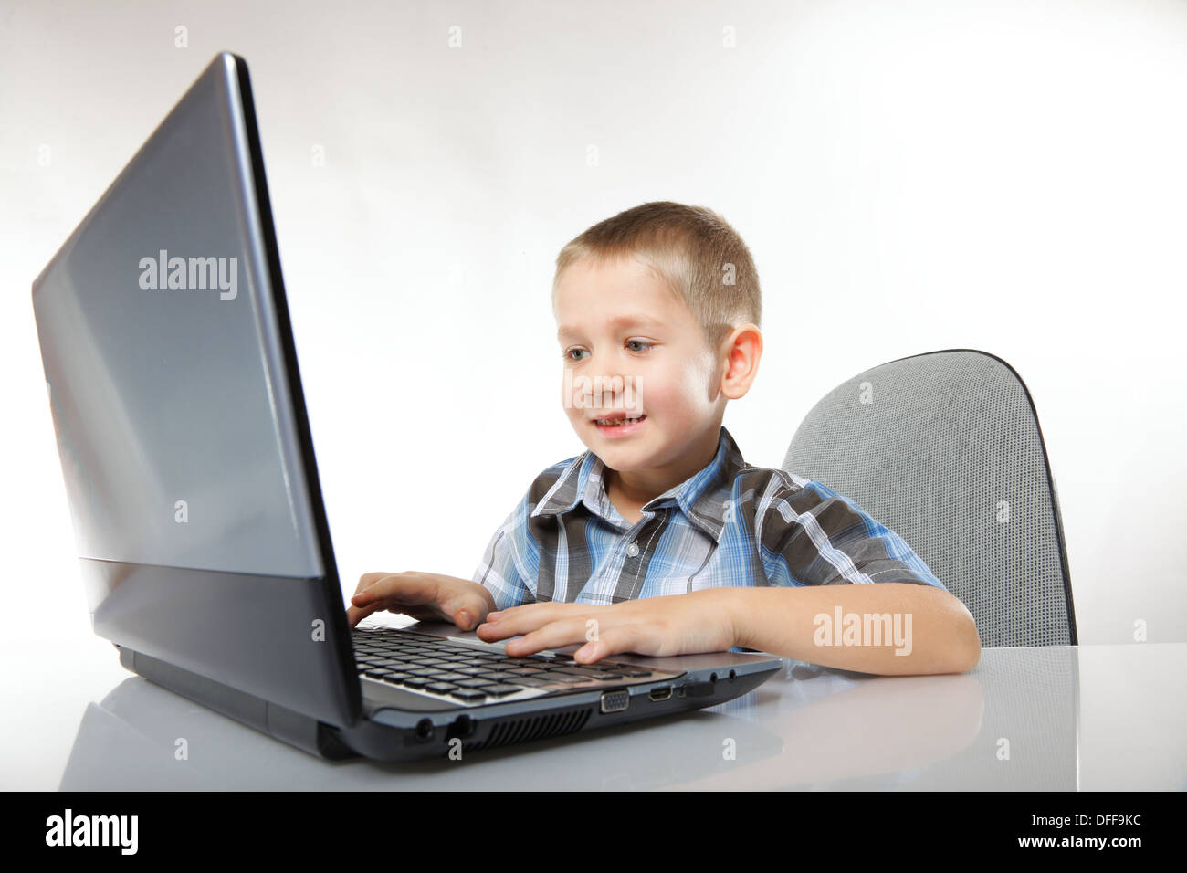 Computer addiction emotional child boy with laptop notebook playing ...
