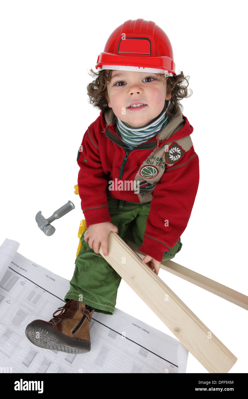 Little kid sat with plank of wood and building plans Stock Photo - Alamy