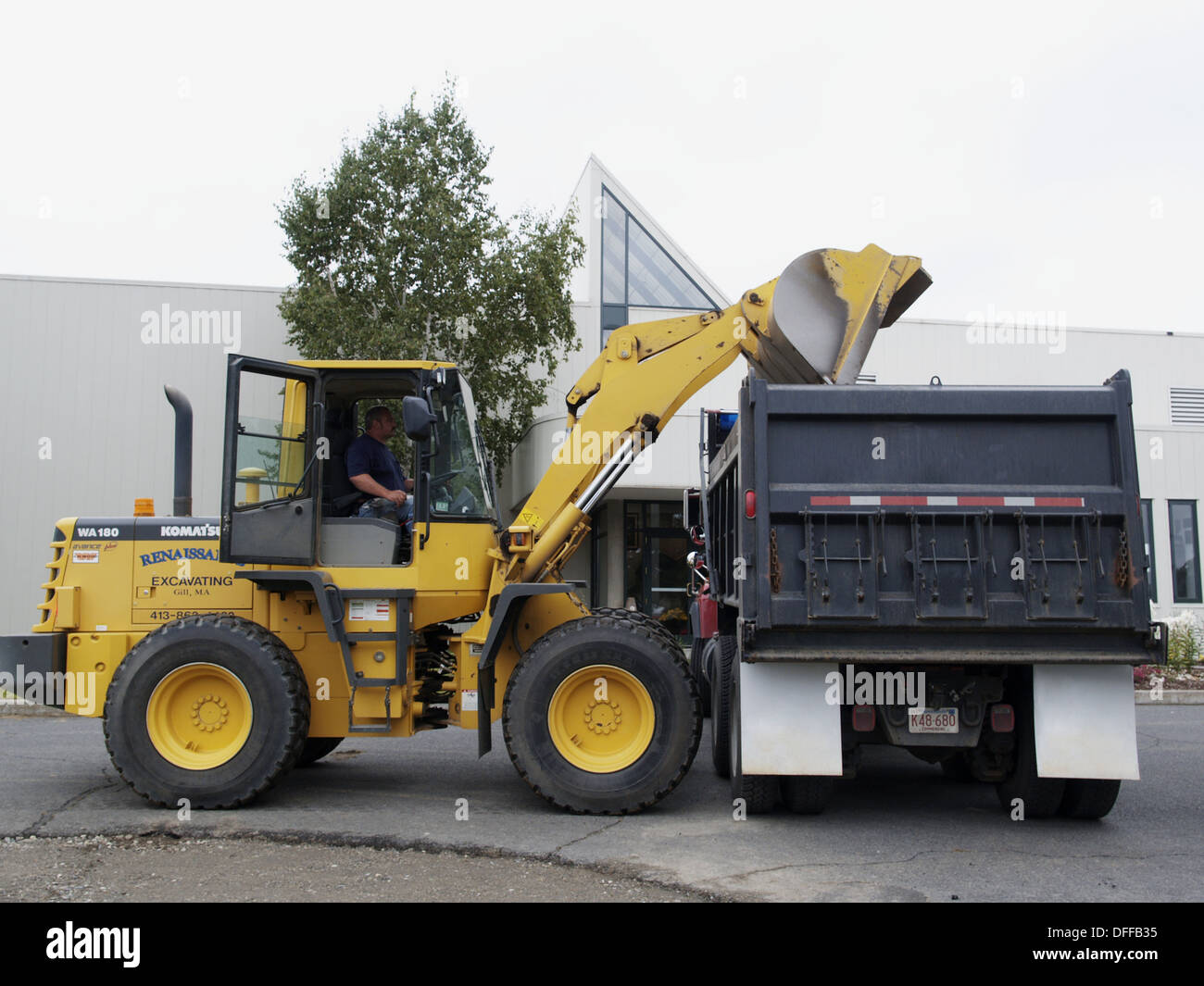 Dump truck and front end loader removing asphalt in Turners Falls Stock ...