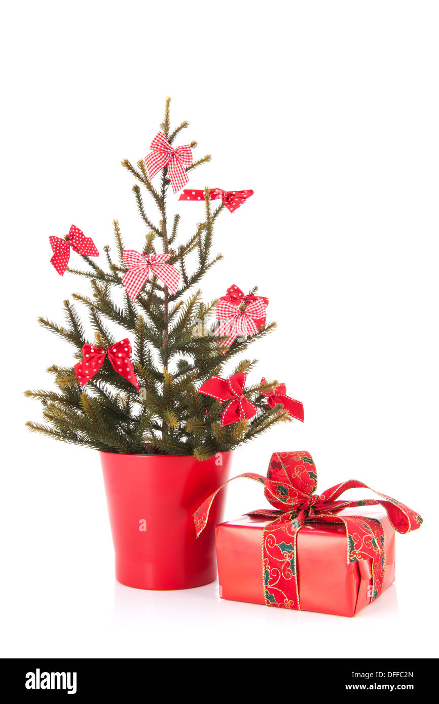 Little red Christmas tree with bows isolated over white background ...