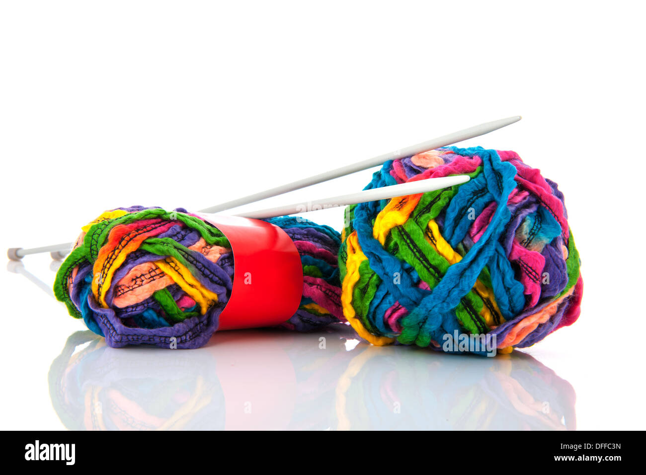 Modern balls wool in many colors with needles isolated over white ...