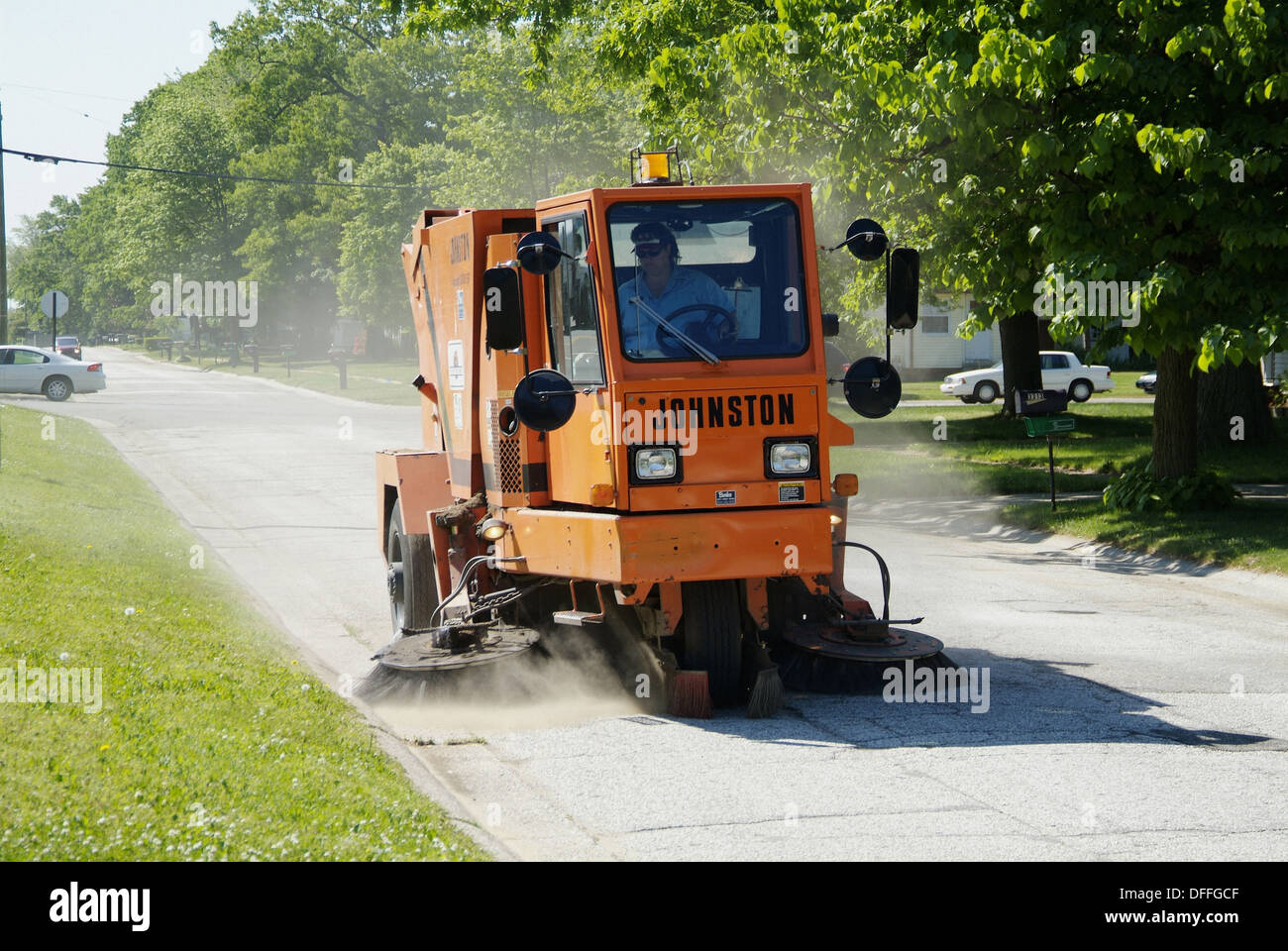Street sweeper cleans city streets Stock Photo - Alamy