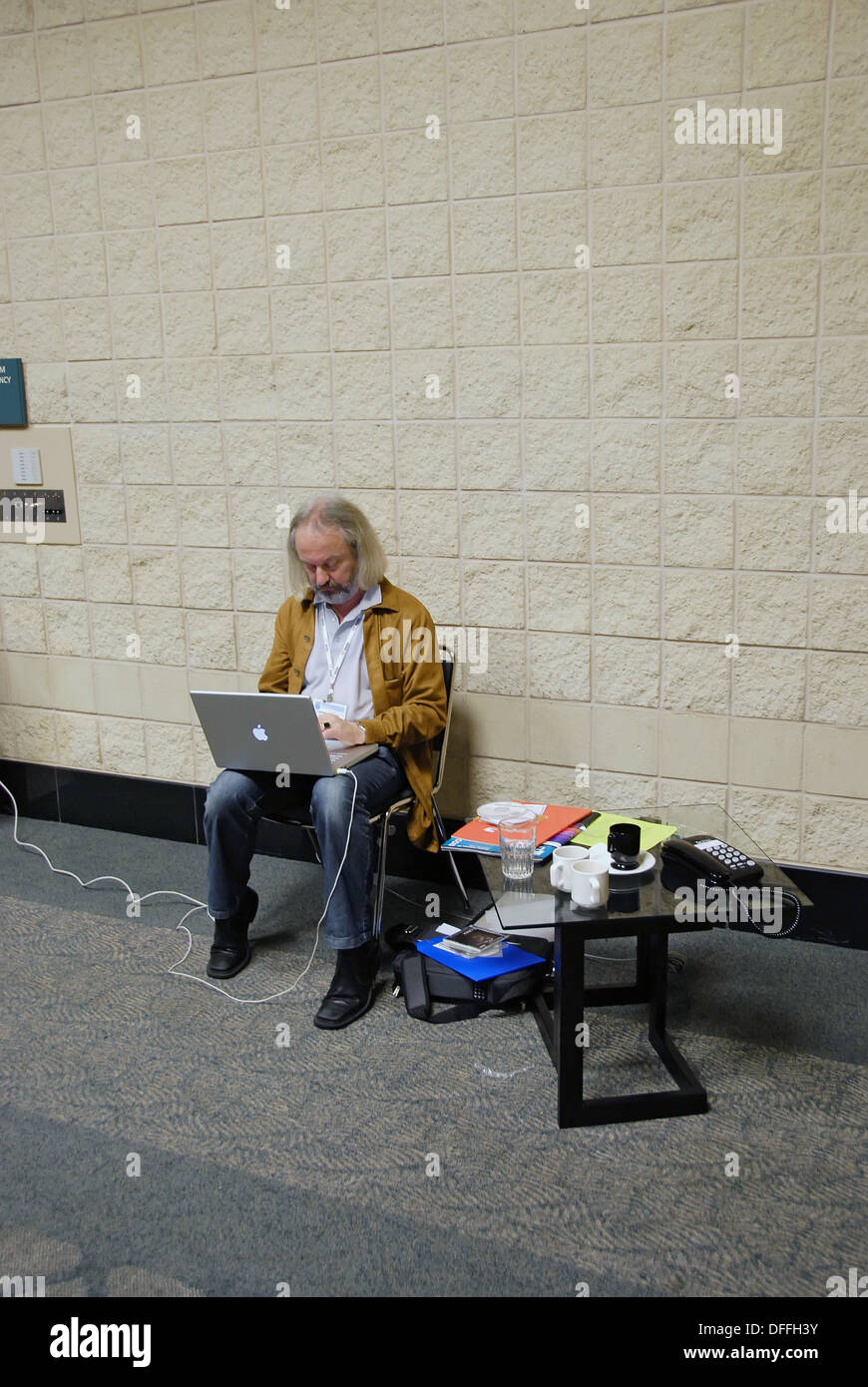 Adult businessman professional works on wireless laptop computer while ...