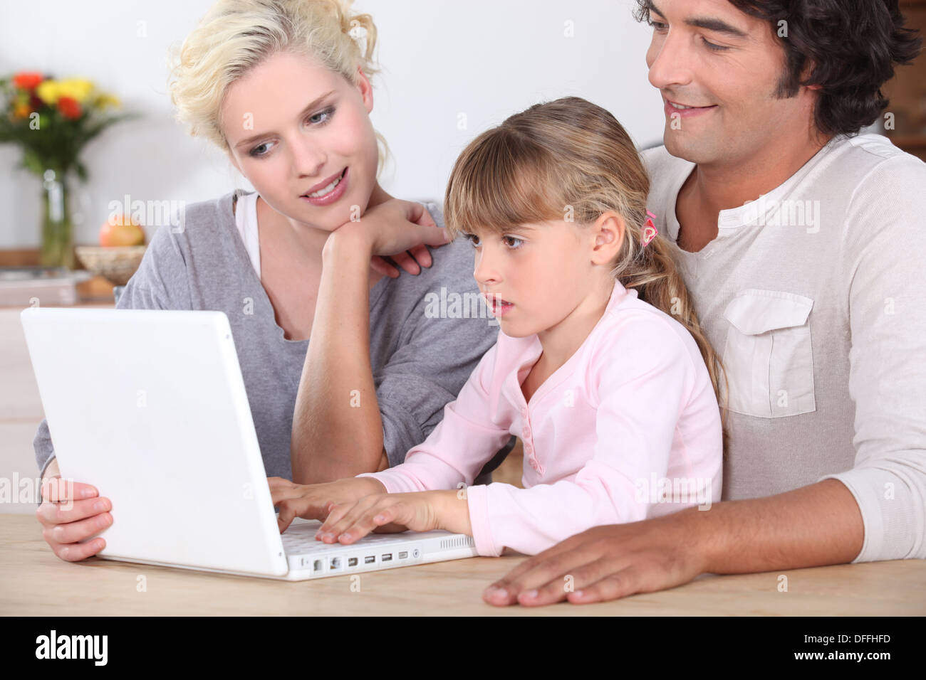Parents with daughter and computer Stock Photo - Alamy