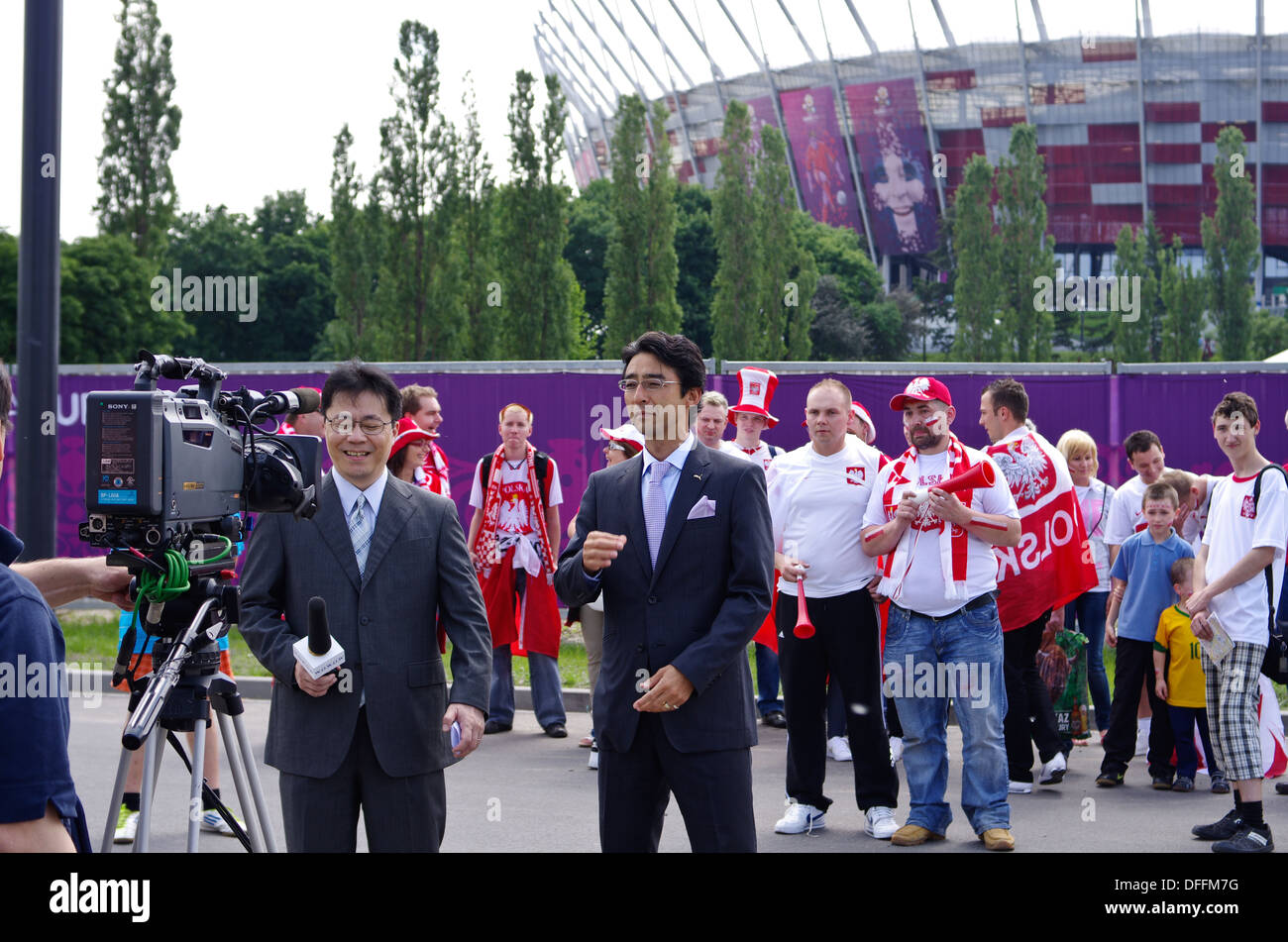 Japanese film team with Polish football fans in front of the National ...