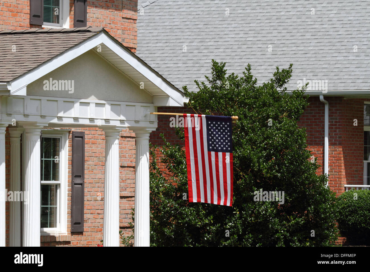 American flag front of house hi-res stock photography and images - Alamy