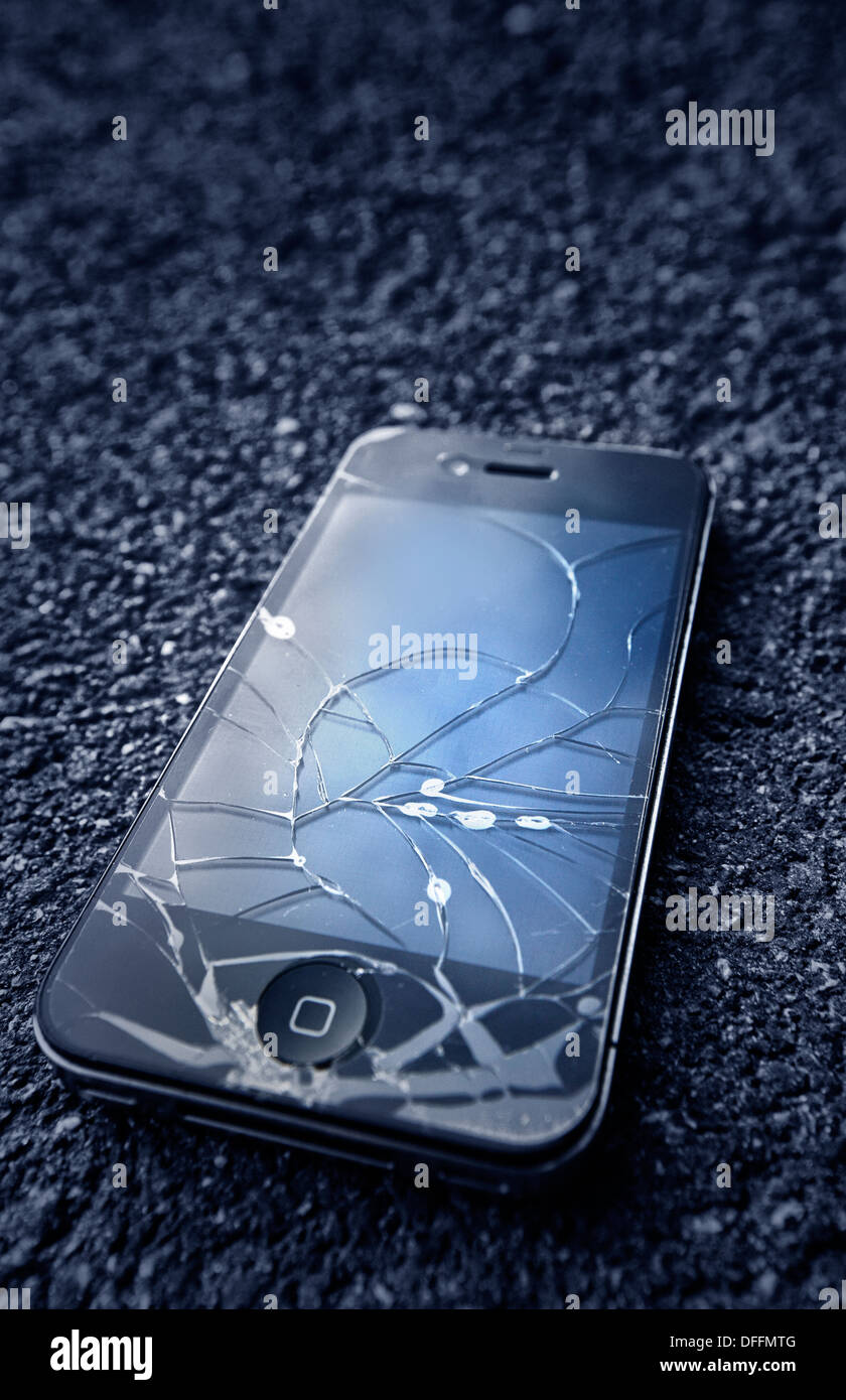Black iPhone with broken display laying on asphalt Stock Photo - Alamy