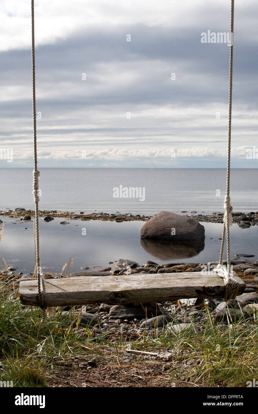 wooden swing with ropes on sea shore background Stock Photo - Alamy