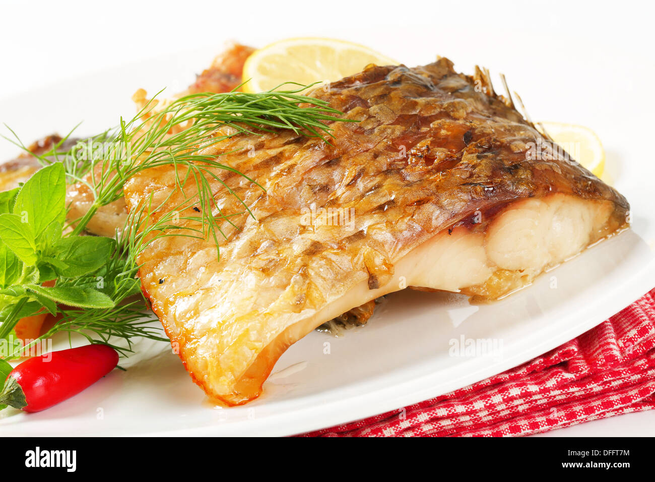 Oven baked carp fillets with crispy skin Stock Photo - Alamy