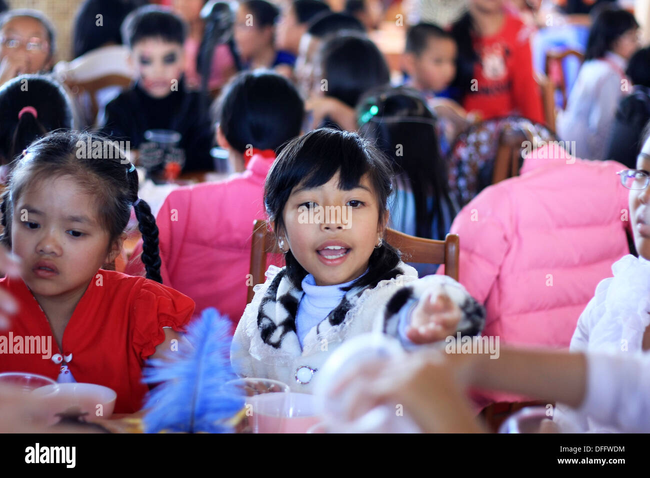 Little girl with her classmate at party in the occasion of Halloween ...