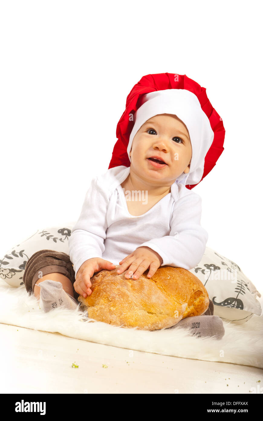 Happy chef baby with round bread sitting down Stock Photo - Alamy