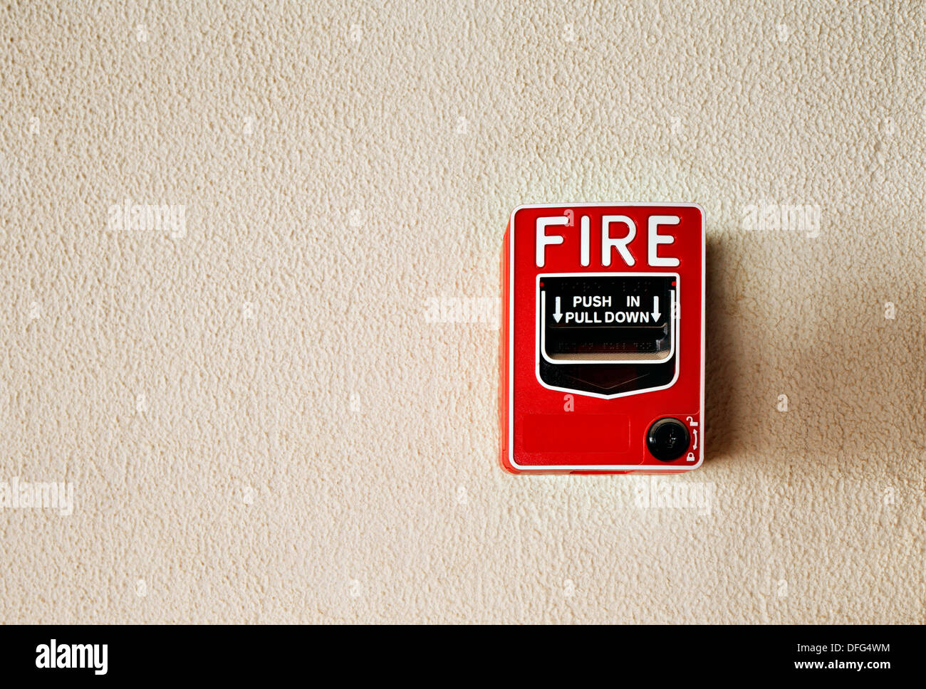 Fire alarm button on a wall Stock Photo - Alamy