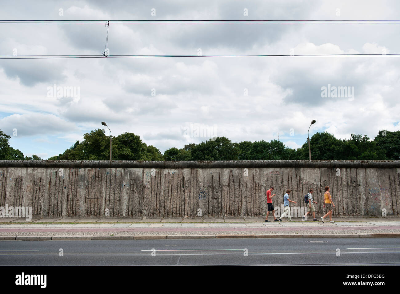 A group of people walking in front of the Berlin Wall at Bernauer ...