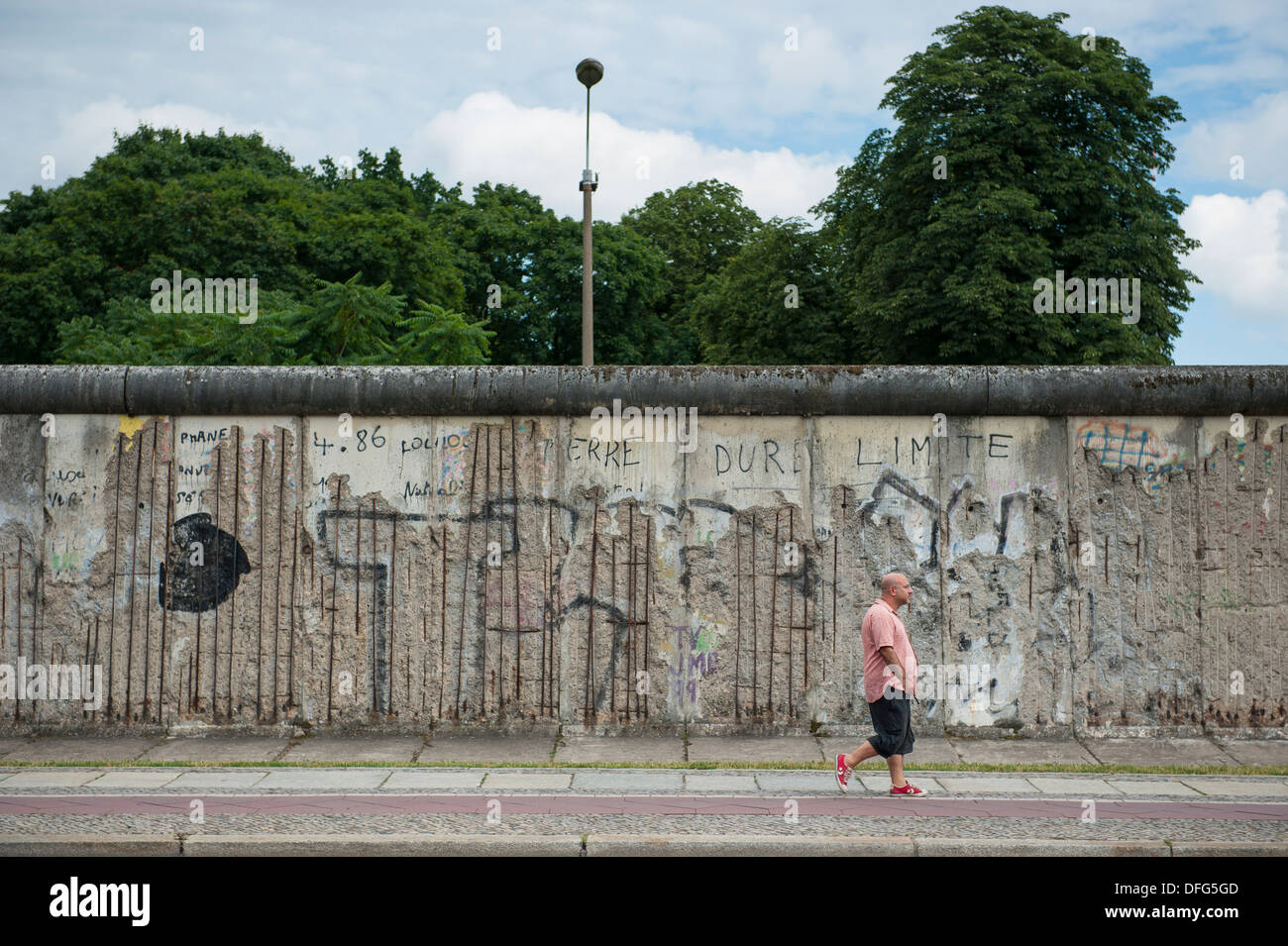 A man walking in front of the Berlin Wall at Bernauer Strasse, Berlin ...