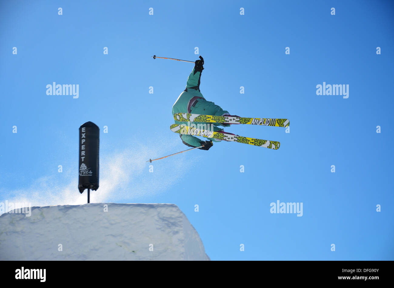 A freestyle skier performs an aerial trick as he launches from a jump in Les Arcs, France Stock ...