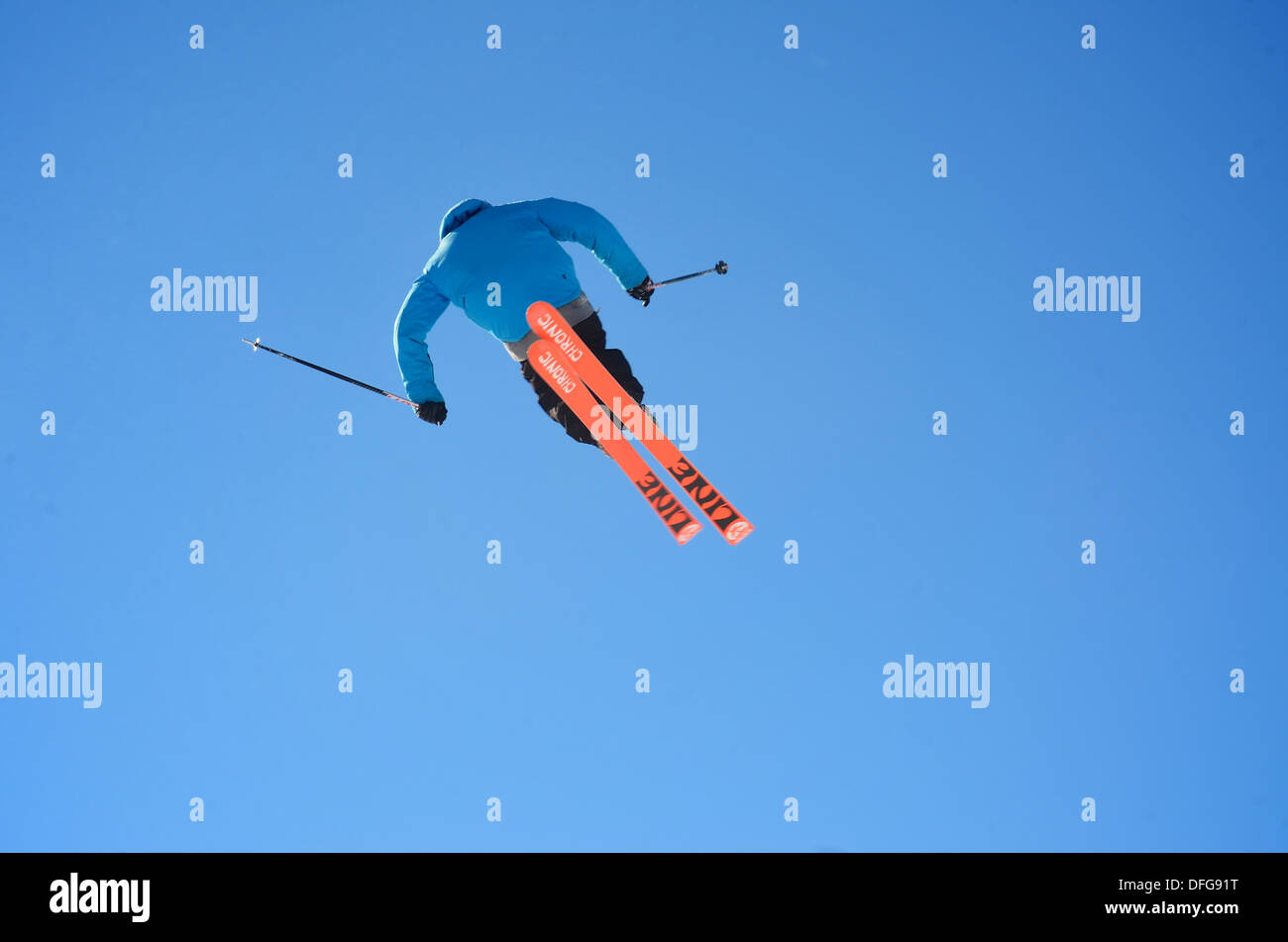 A freestyle skier performs an aerial trick as he launches from a jump ...