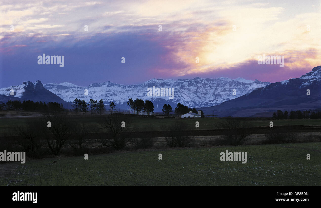 An Underberg farm framed by snow capped mountain peaks in the Southern ...