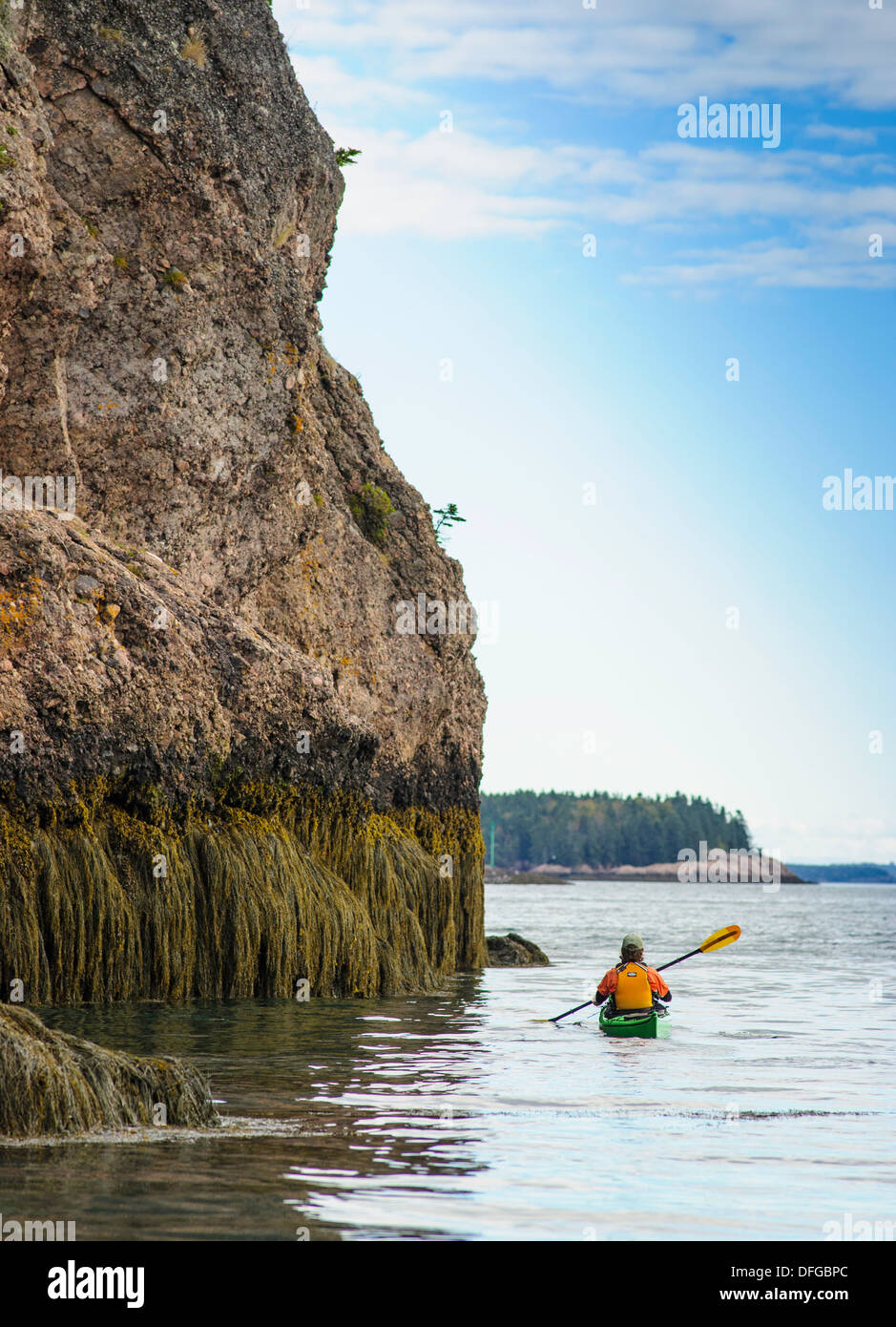 Kayaking by cliff Stock Photo - Alamy