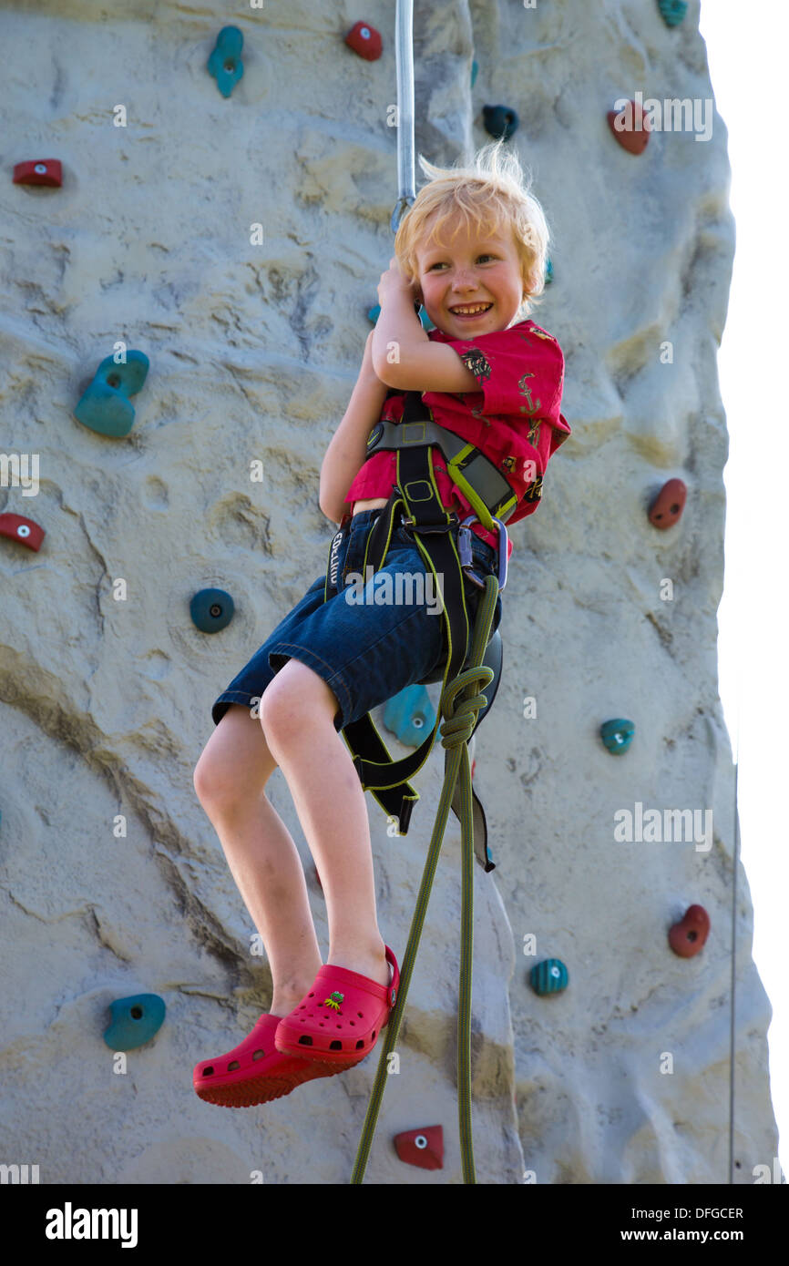 Young Boy descending a Climbing Wall Stock Photo - Alamy