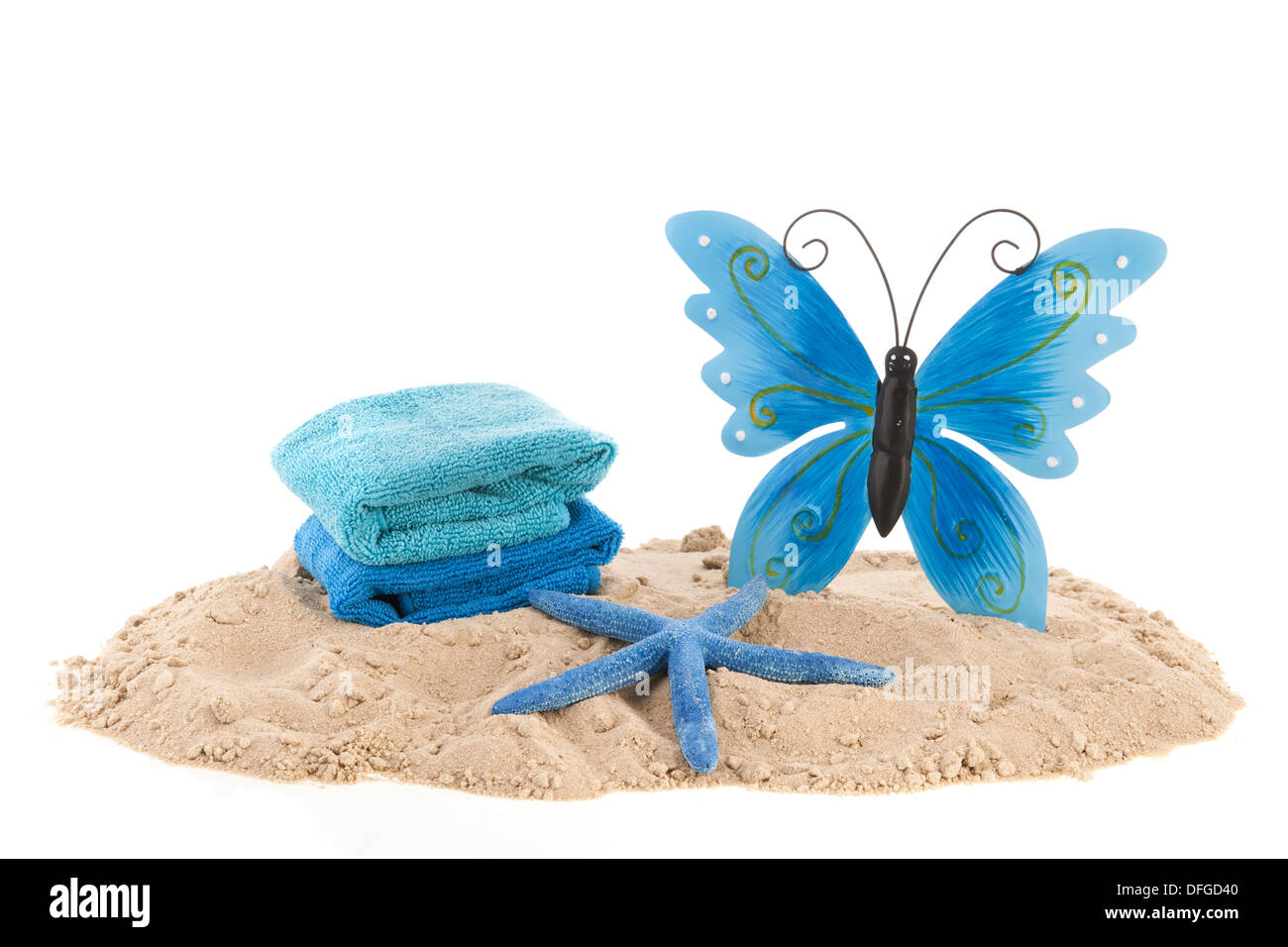 Sand at the beach with towels and butterfly Stock Photo - Alamy