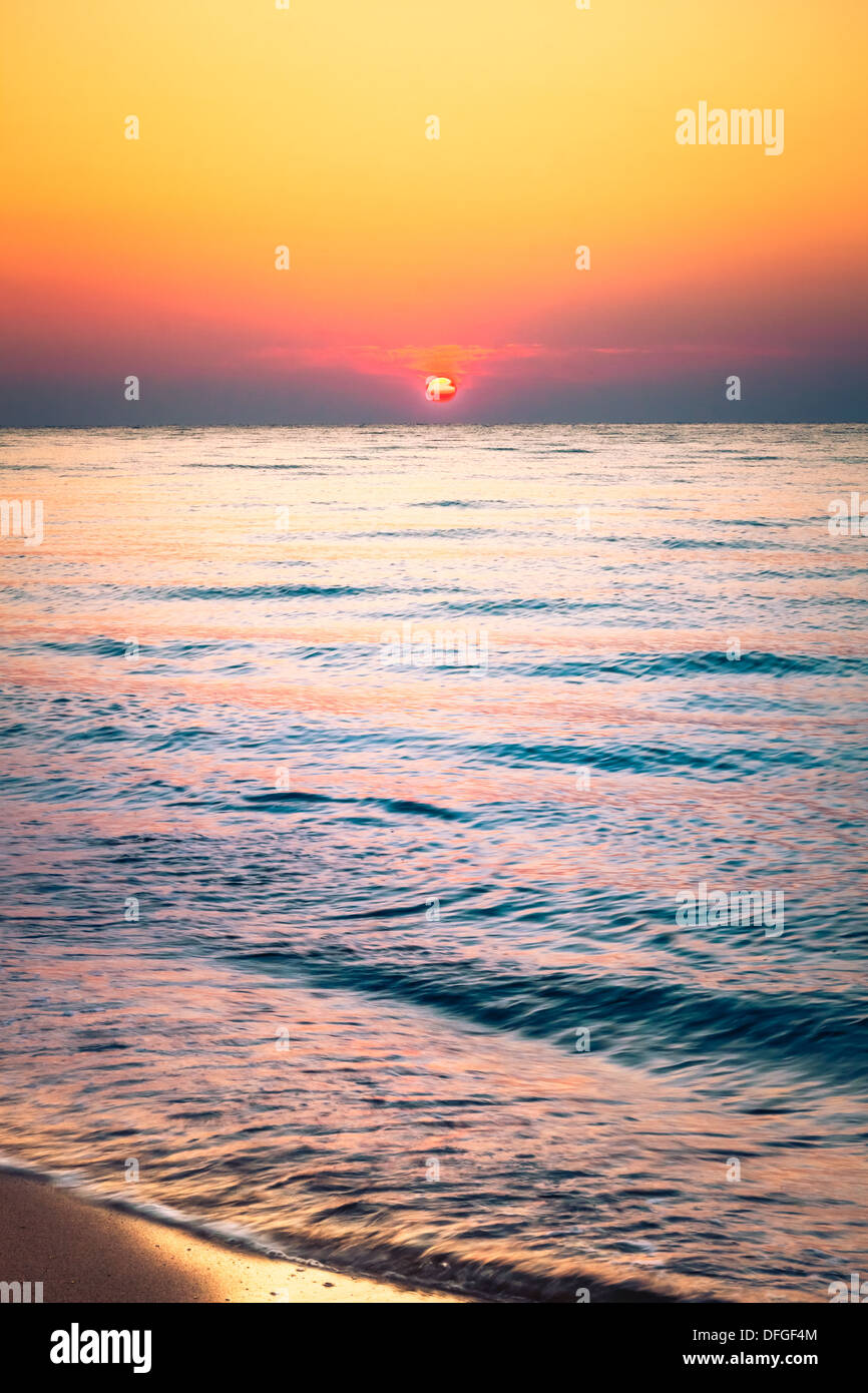 Soft sea ocean waves wash over golden sand background. Sunset, sunrise ...