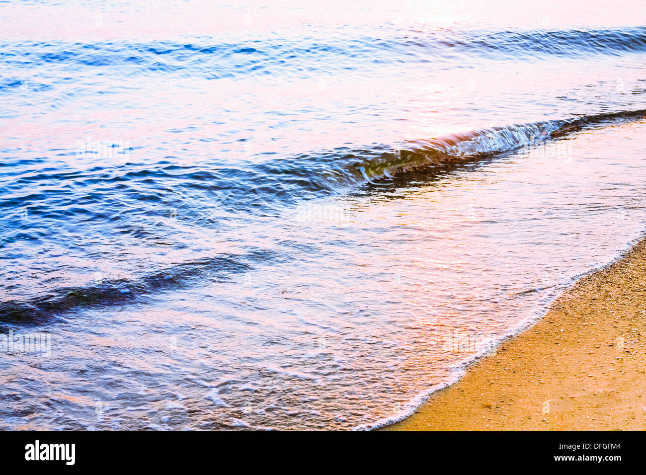 Soft sea ocean waves wash over golden sand background. Sunset, sunrise ...