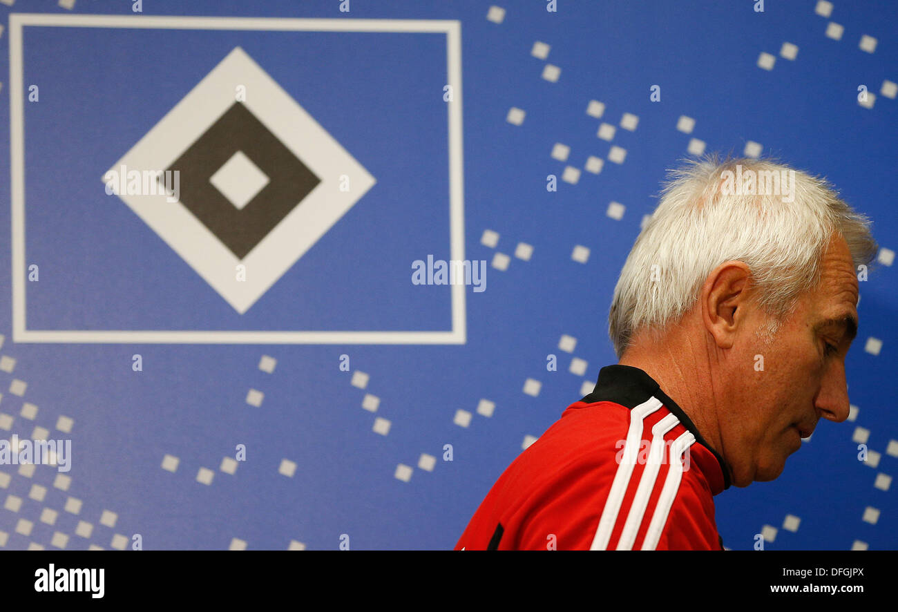 Hamburg's coach Bert van Marwijk passes by the logo of the club during ...
