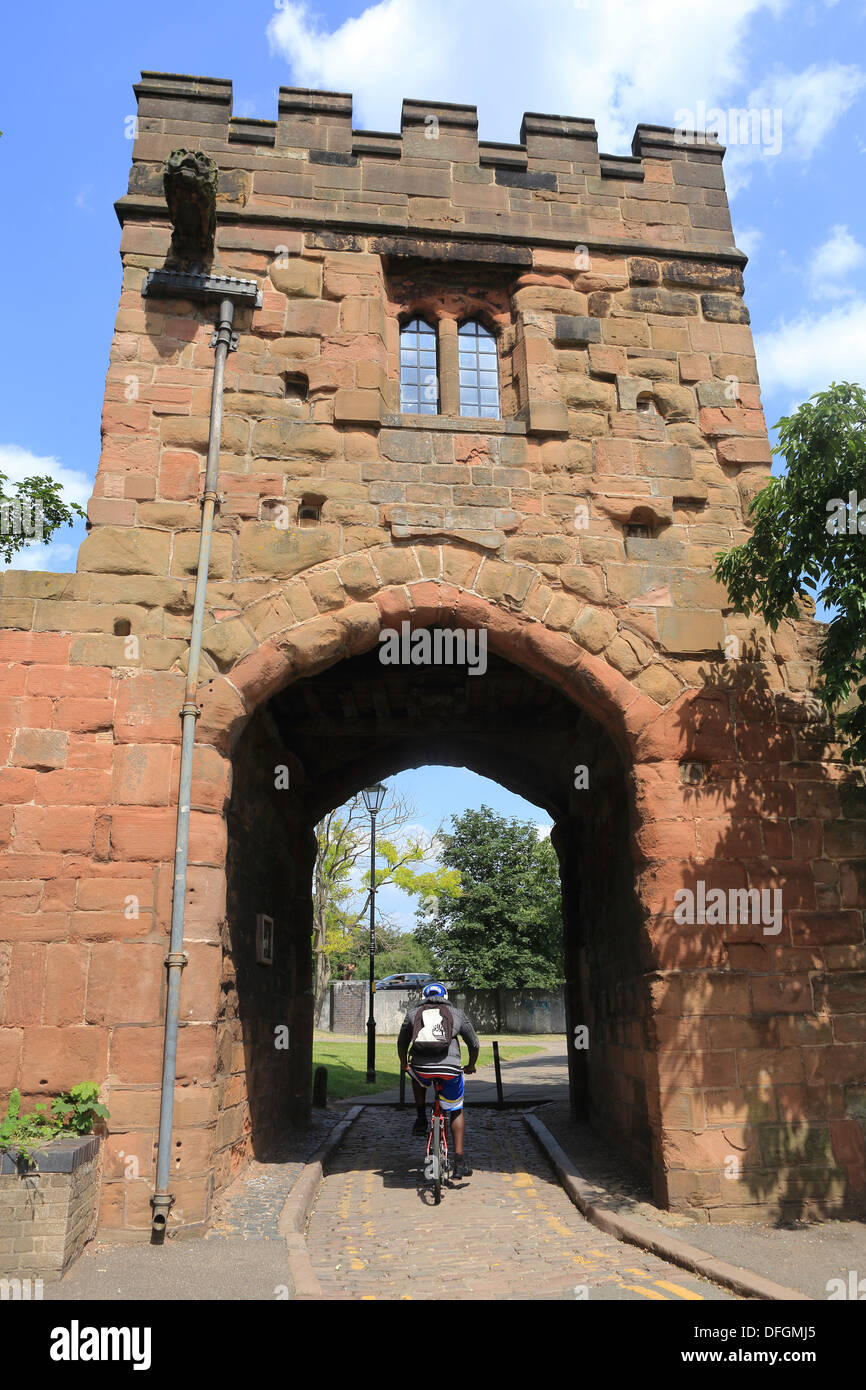 Cycling through Cook Street Gate, part of the medieval town wall, in ...